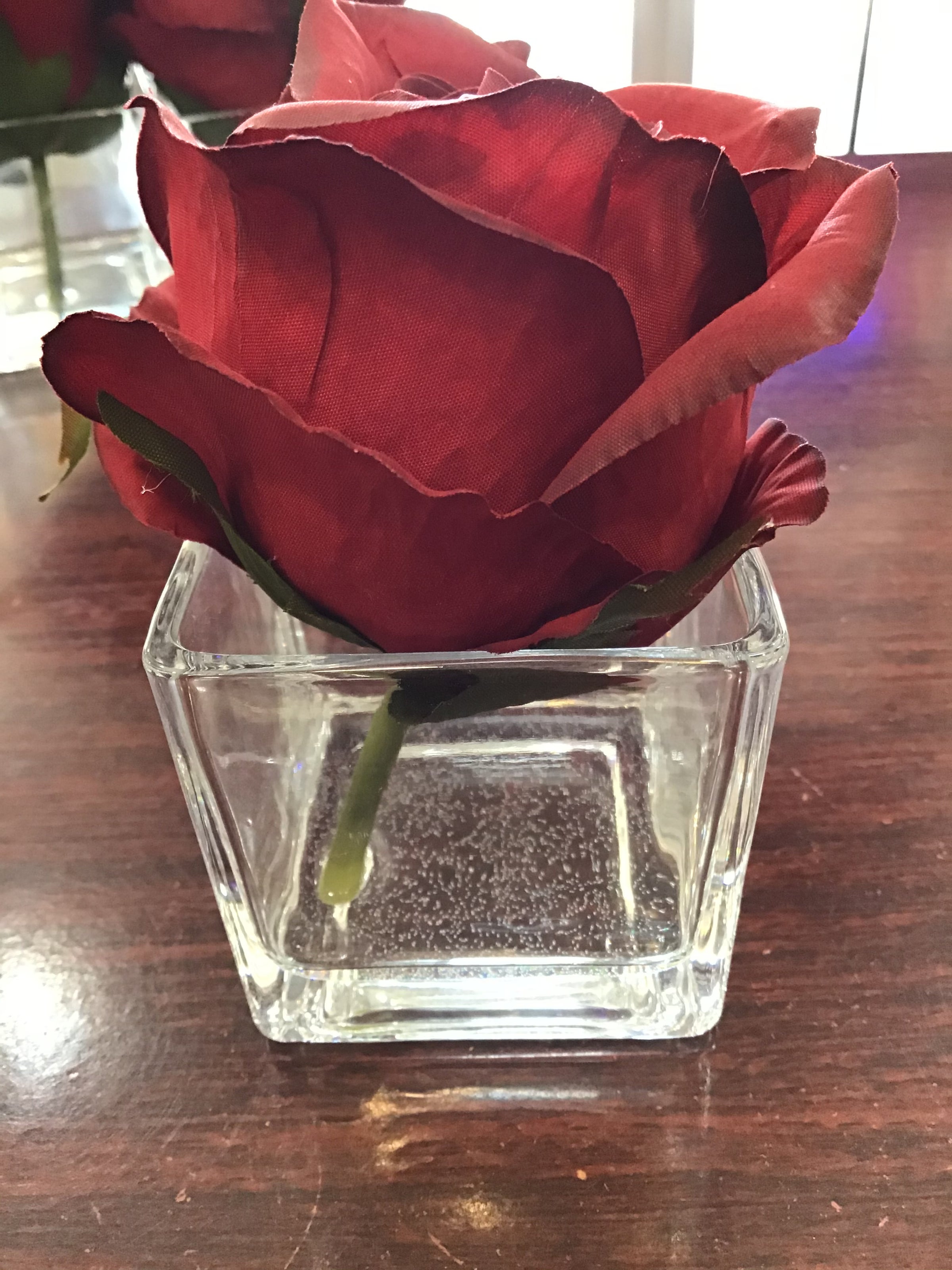 single red rose on table